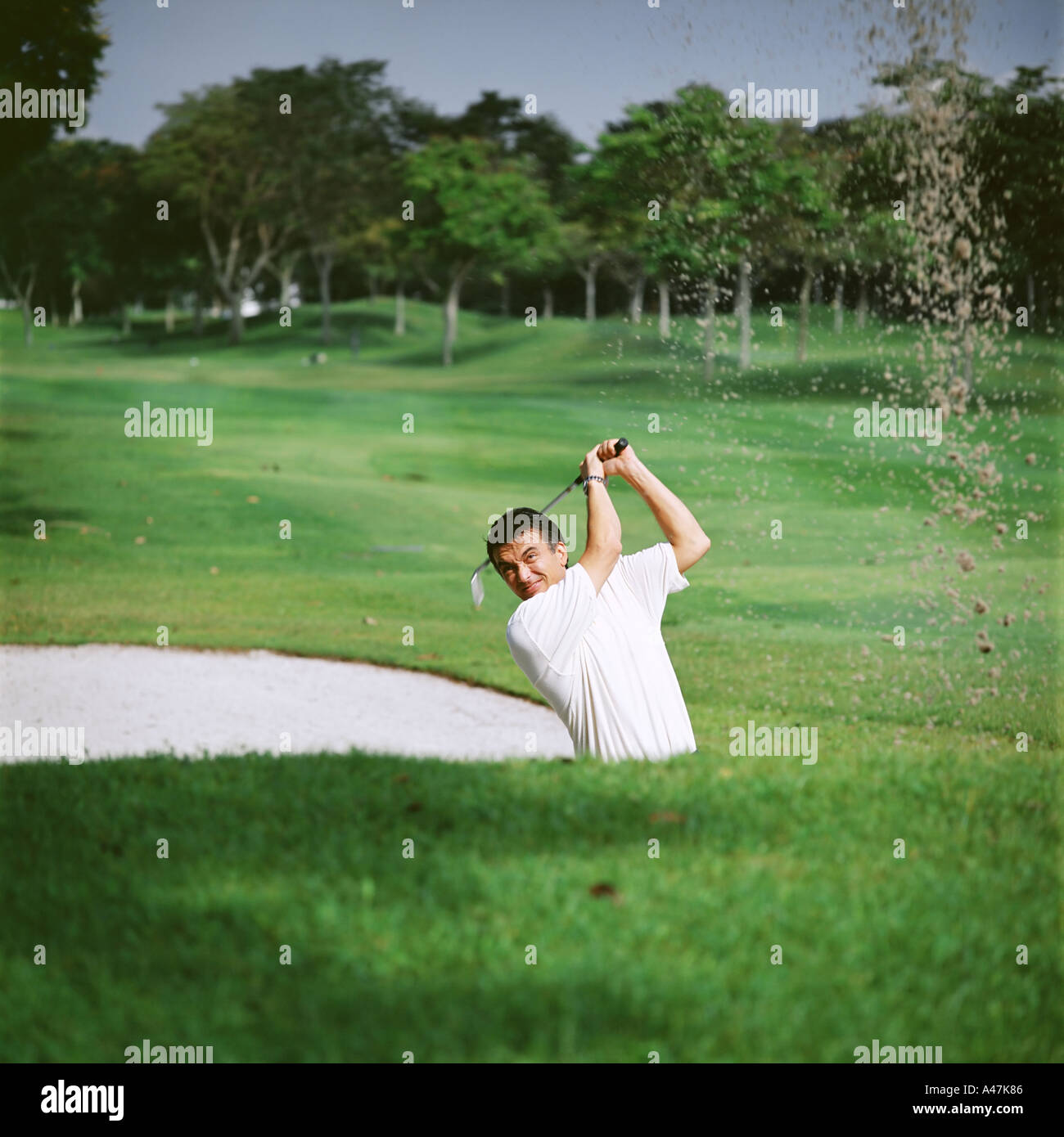 Golfer in sand trap Stock Photo - Alamy