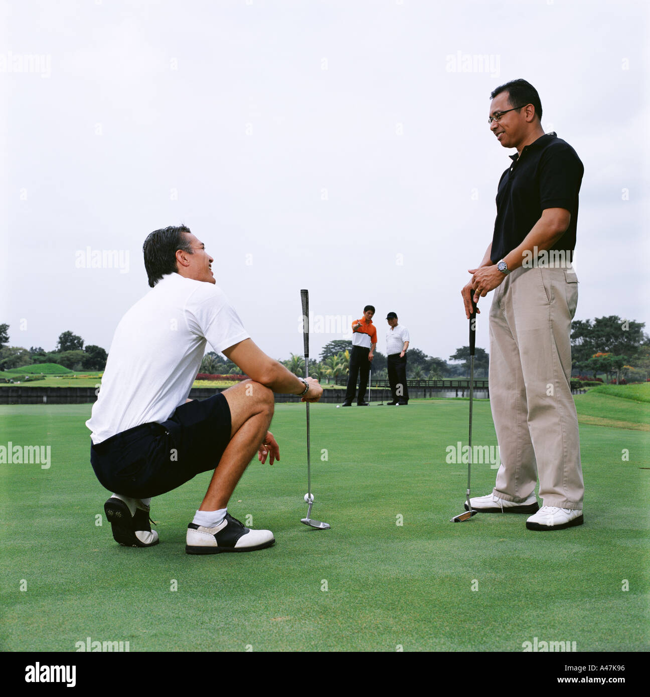 Man crouching playing golf hi-res stock photography and images - Alamy