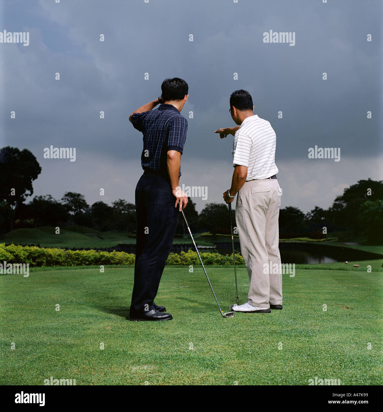 Two men playing golf Stock Photo - Alamy