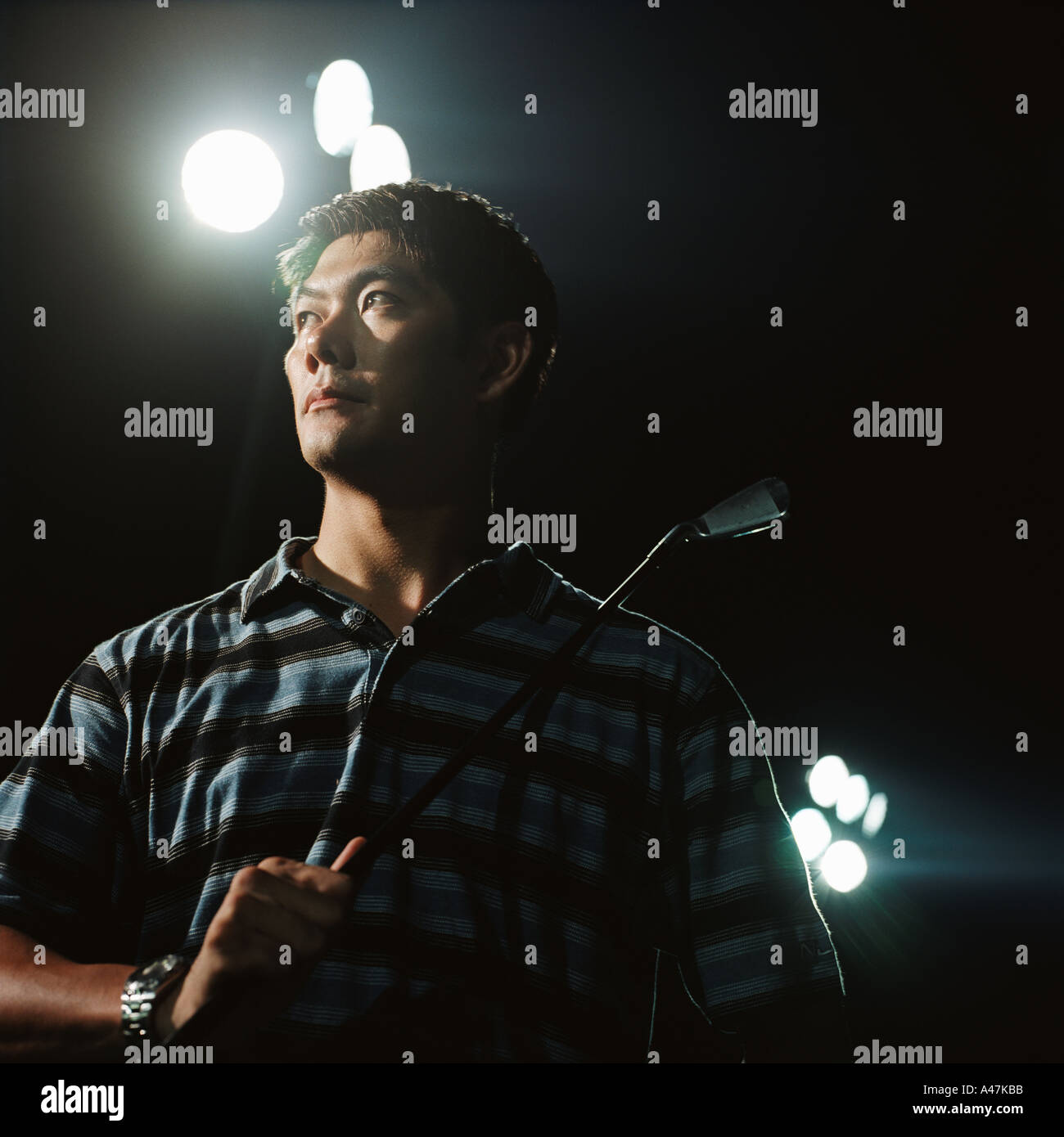 Man on driving range at night Stock Photo - Alamy