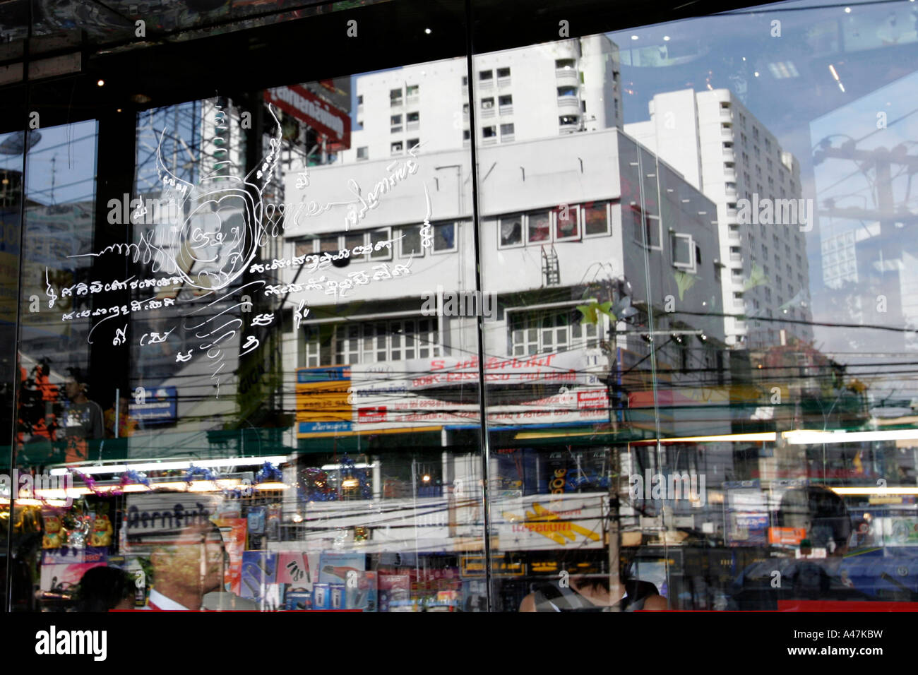 A reflection in a shop window in Bangkok in Thailand Stock Photo - Alamy