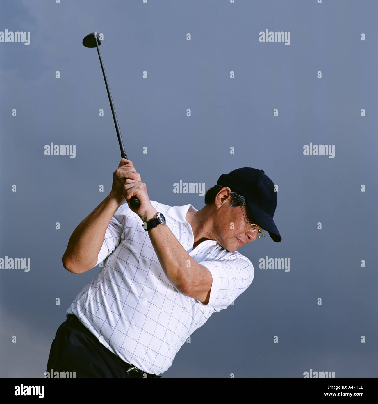Man swinging golf club Stock Photo - Alamy