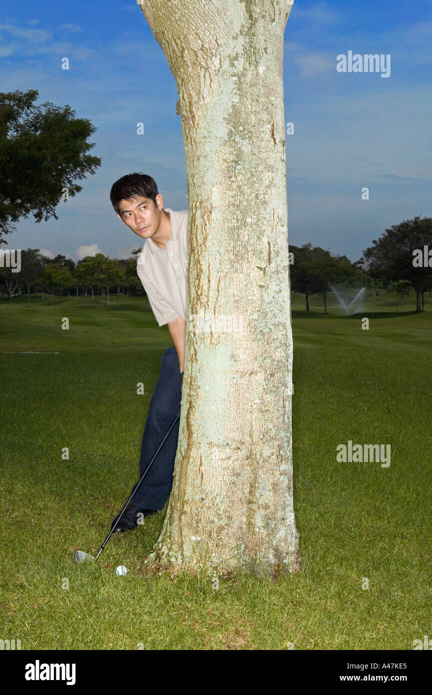 Asian man playing golf Stock Photo - Alamy