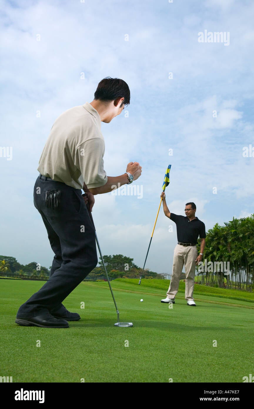 Two men playing golf Stock Photo - Alamy