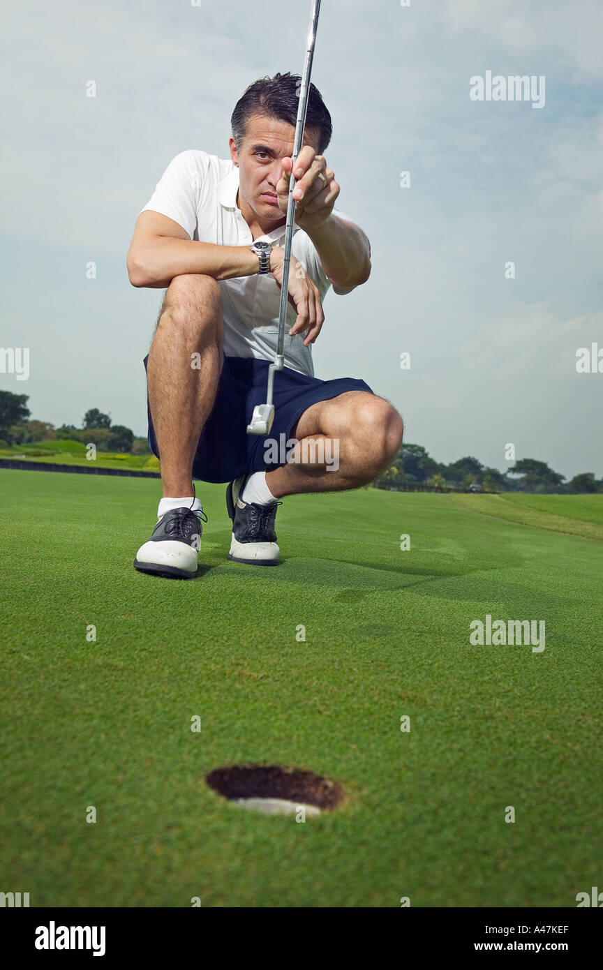 Man crouching playing golf hi-res stock photography and images - Alamy