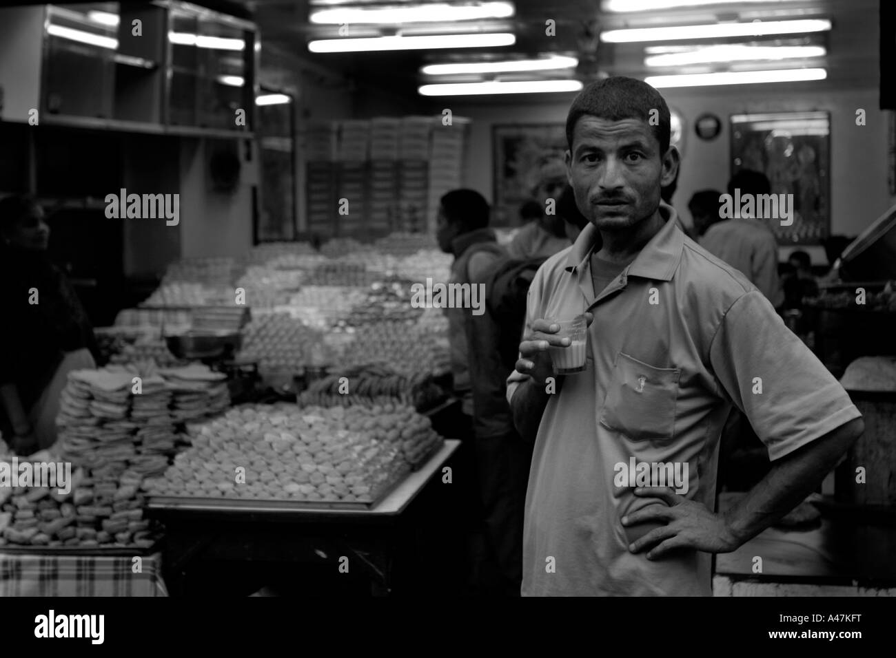 A man gets ready to sip his tea outside a tea shop in Kathmandu in ...
