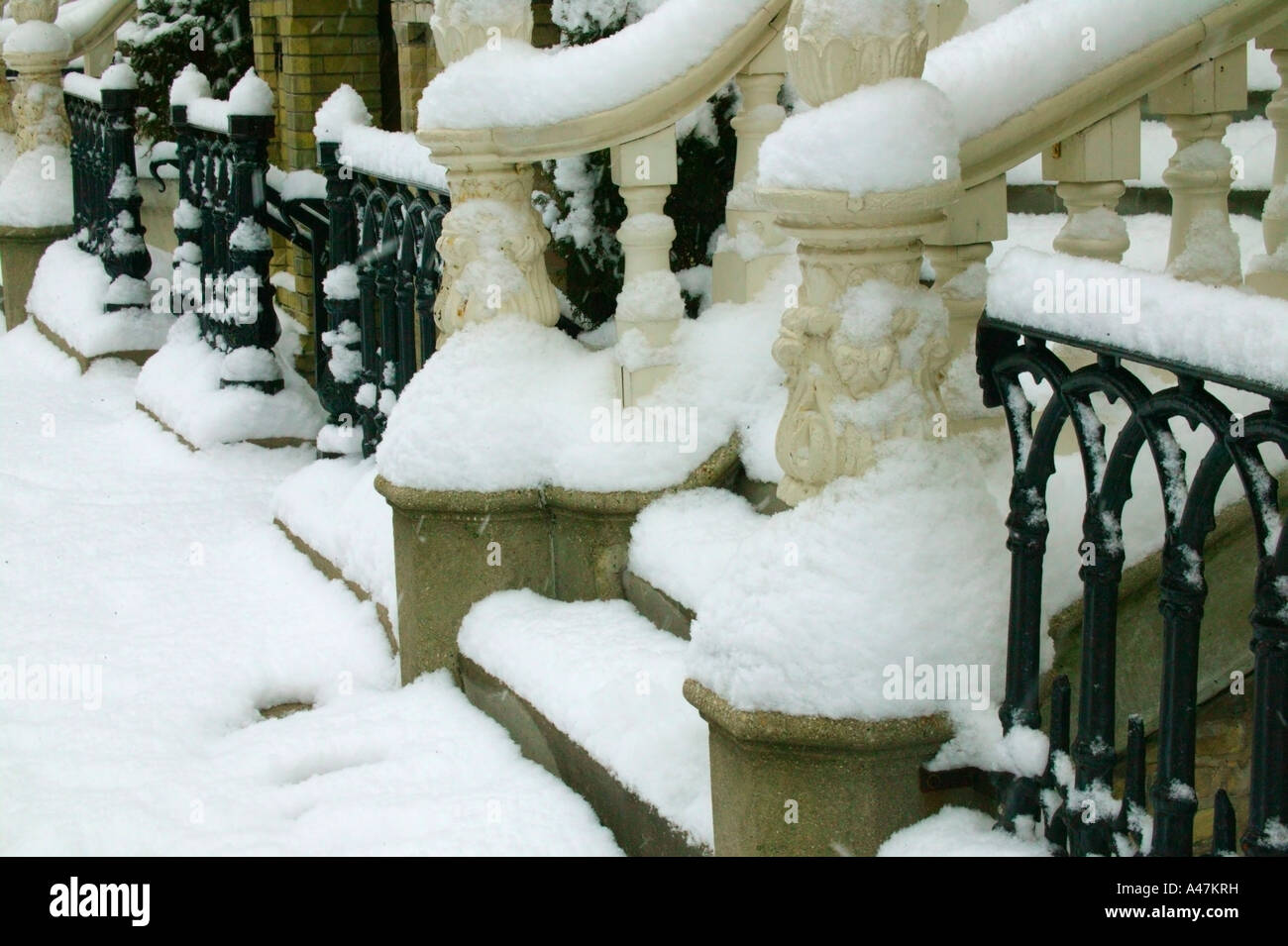 Snow covered steps and wrought iron fence Stock Photo - Alamy