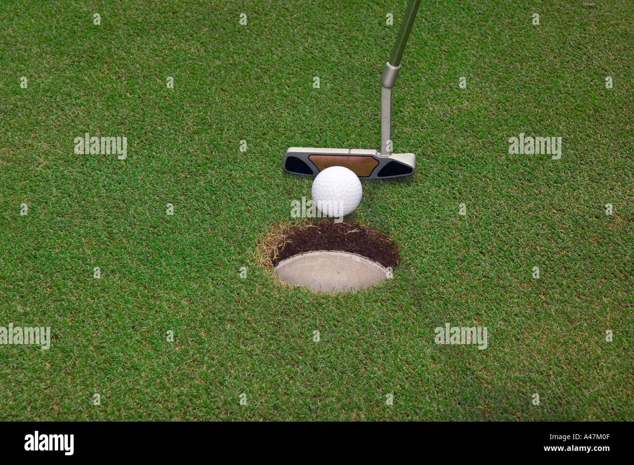 Golf ball and putter Stock Photo - Alamy