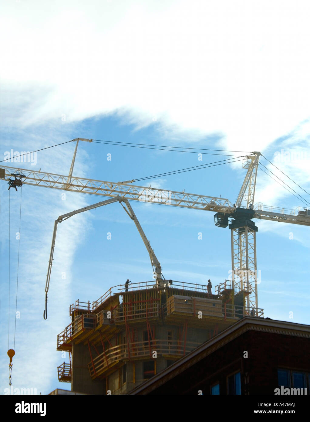 Crane and cement delivery machine at construction site Milwaukee ...