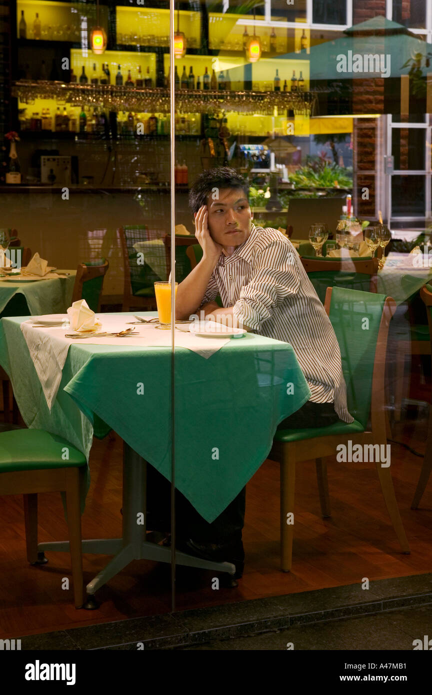 Young man waiting in restaurant Stock Photo - Alamy Young man waiting in restaurant Stock Photo - Alamy