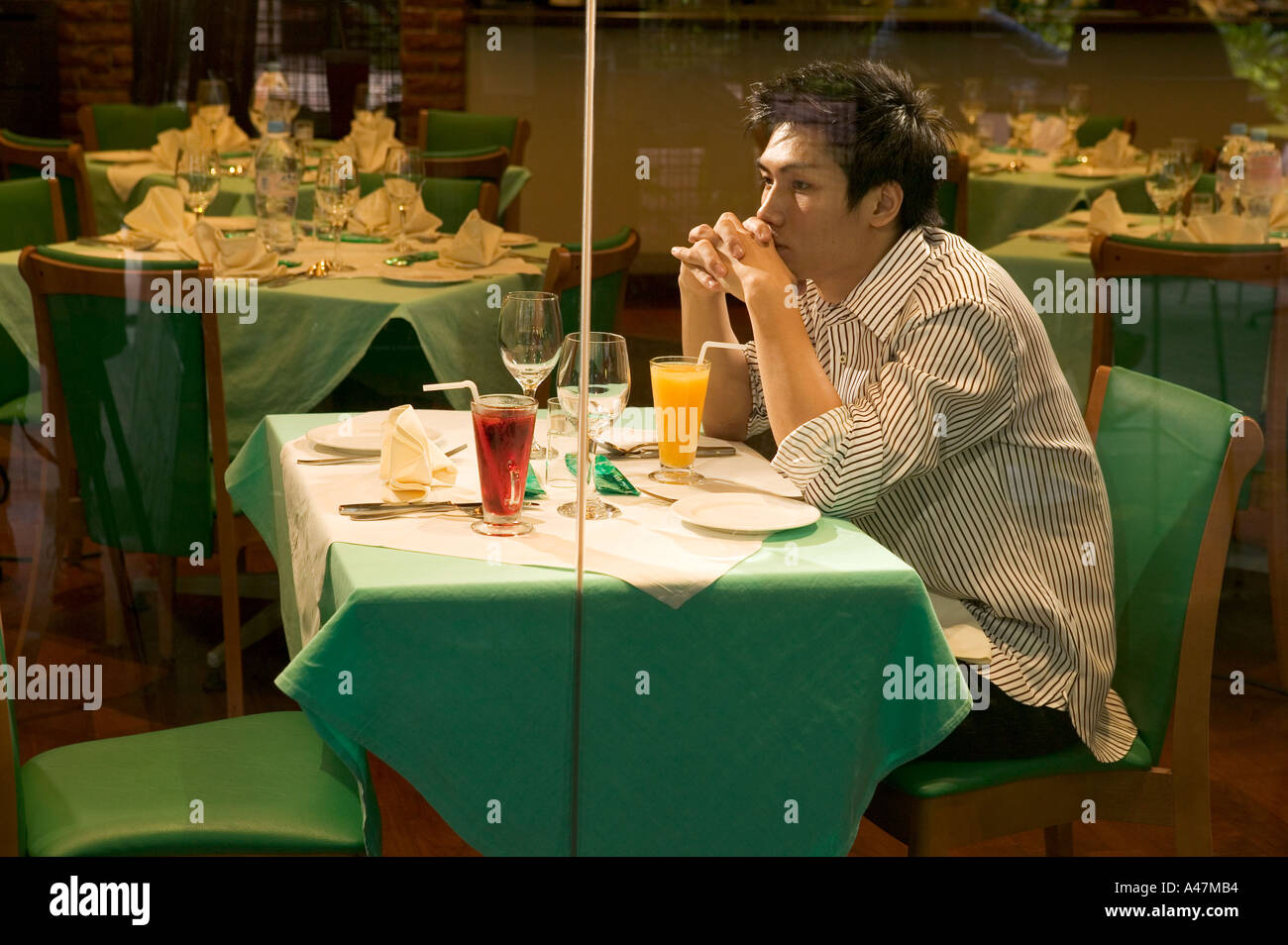 Young man waiting in restaurant Stock Photo - Alamy