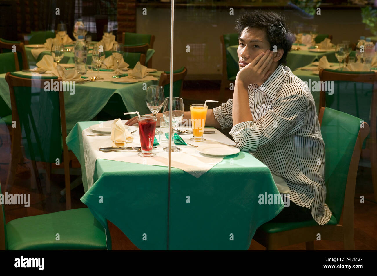 Asian man waiting in restaurant hi-res stock photography and images - Alamy