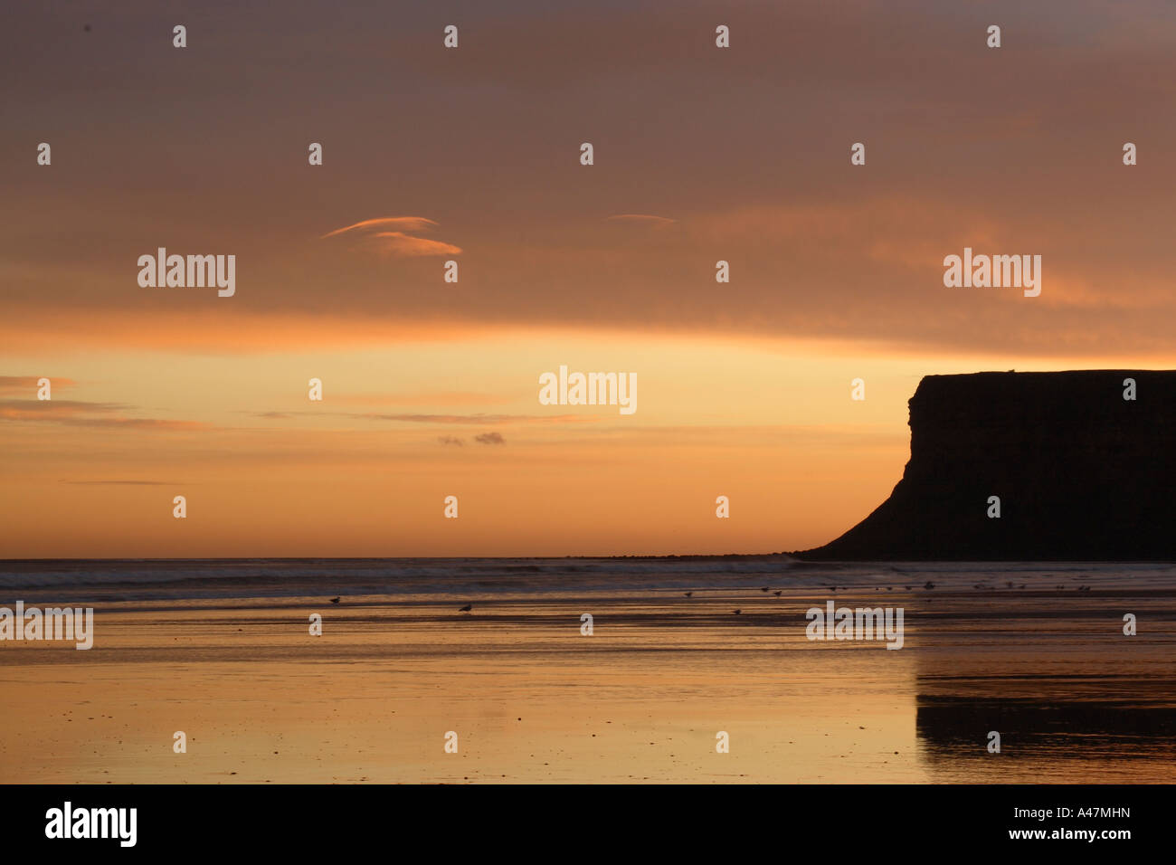 Beach view at Saltburn in North Yorkshire with gold pre sunrise colours ...