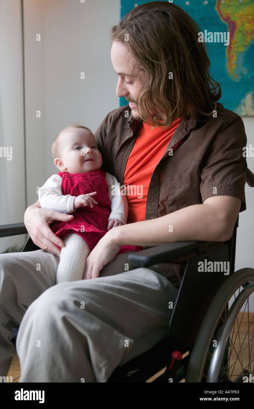 Disabled man with baby Stock Photo - Alamy