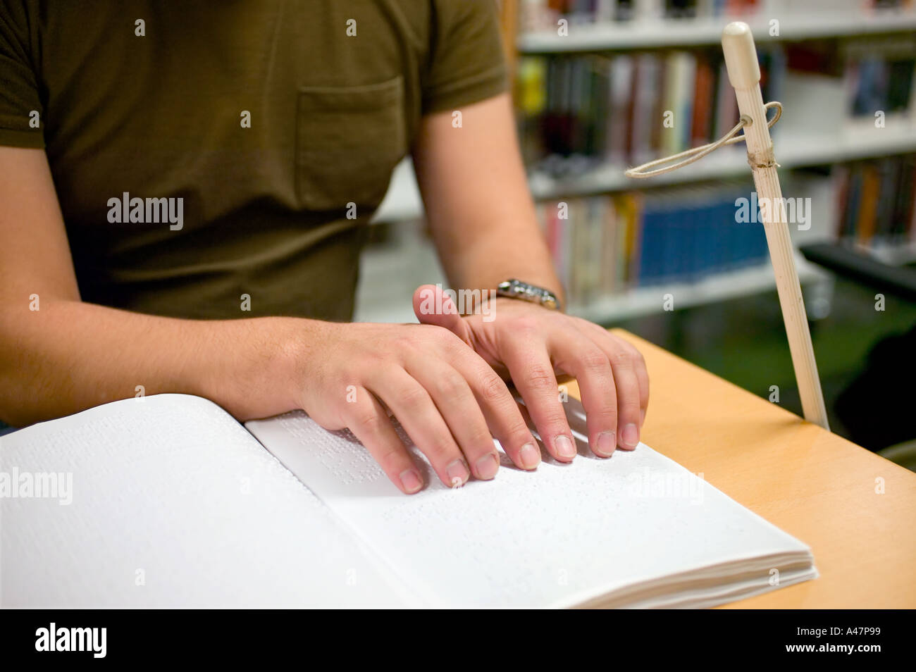 Young man reading braille Stock Photo - Alamy