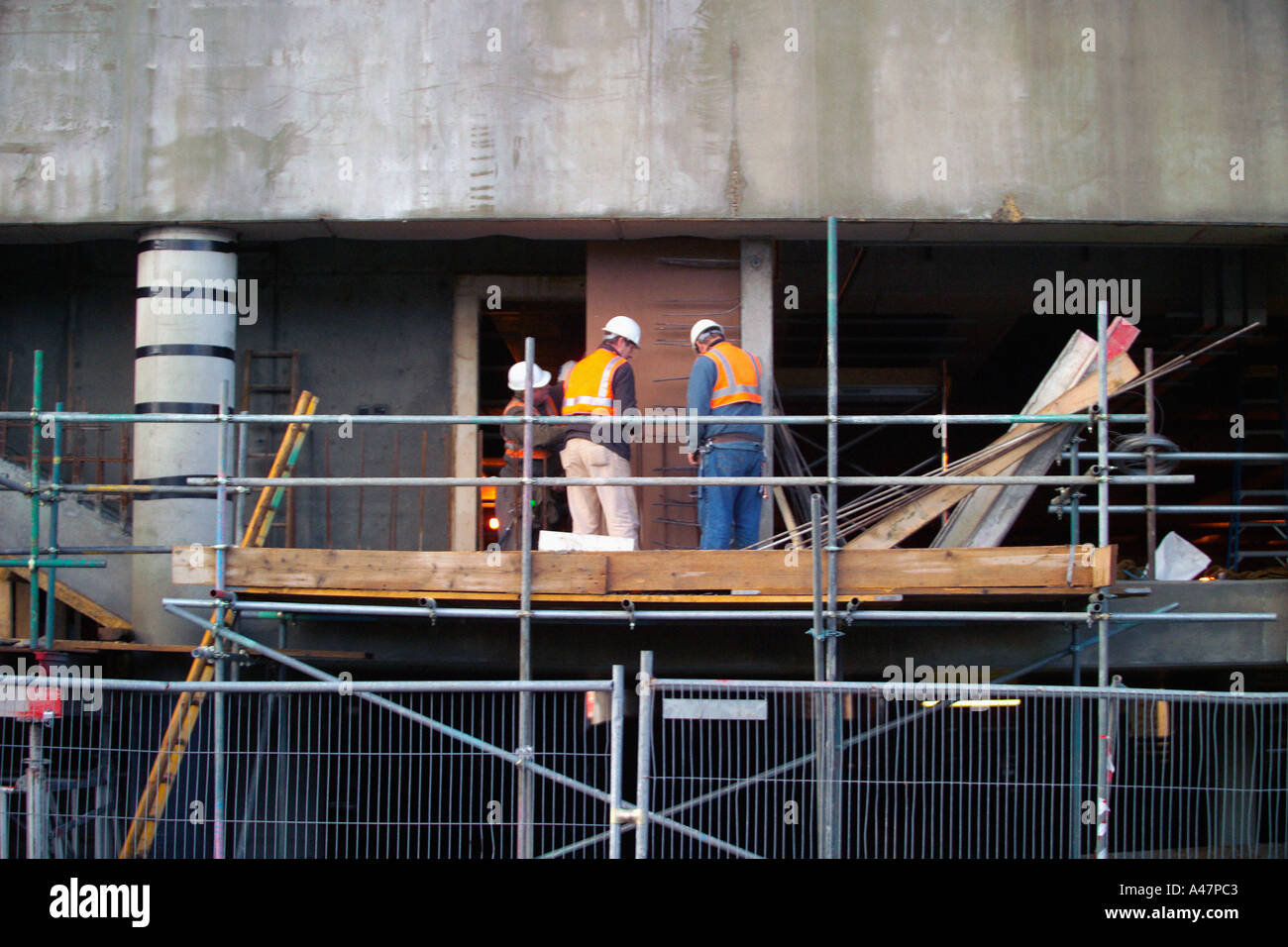 Men up on construction site Stock Photo - Alamy
