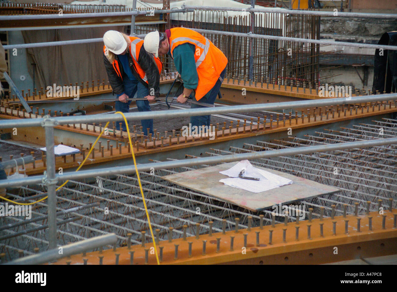 Men up on construction site Stock Photo - Alamy