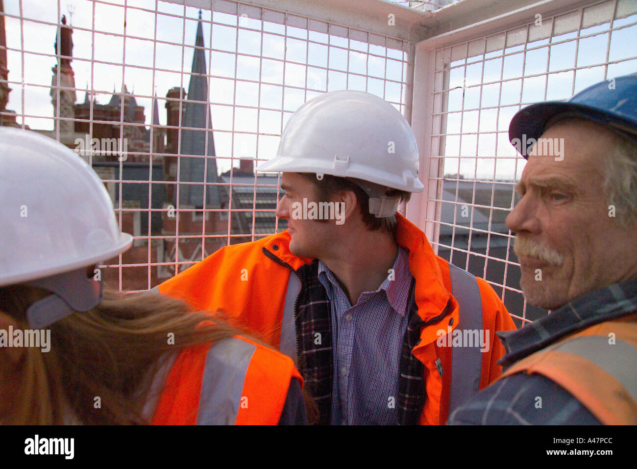 Construction workers in lift Stock Photo - Alamy