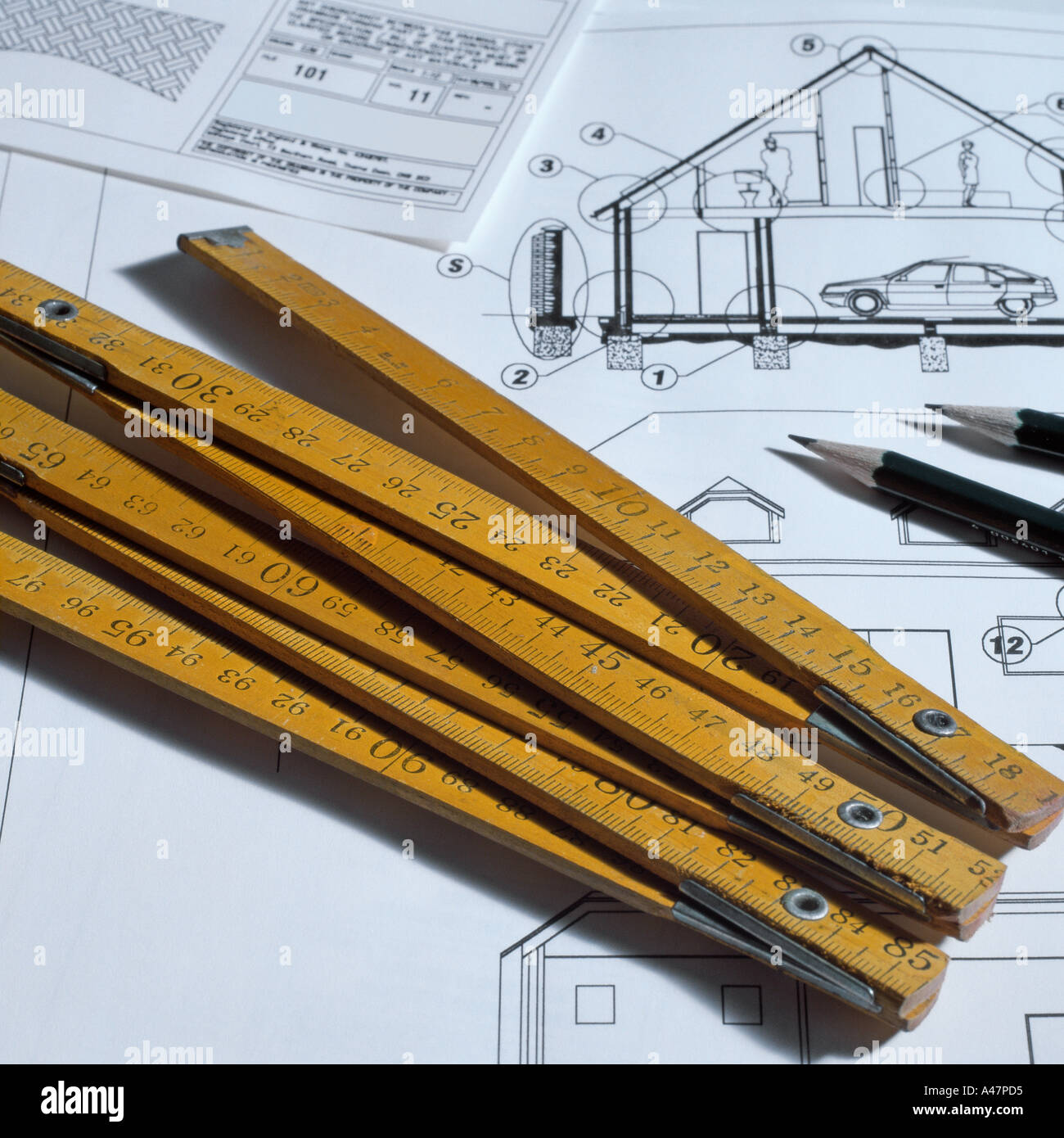 Extendable ruler and architectural blueprints Stock Photo - Alamy