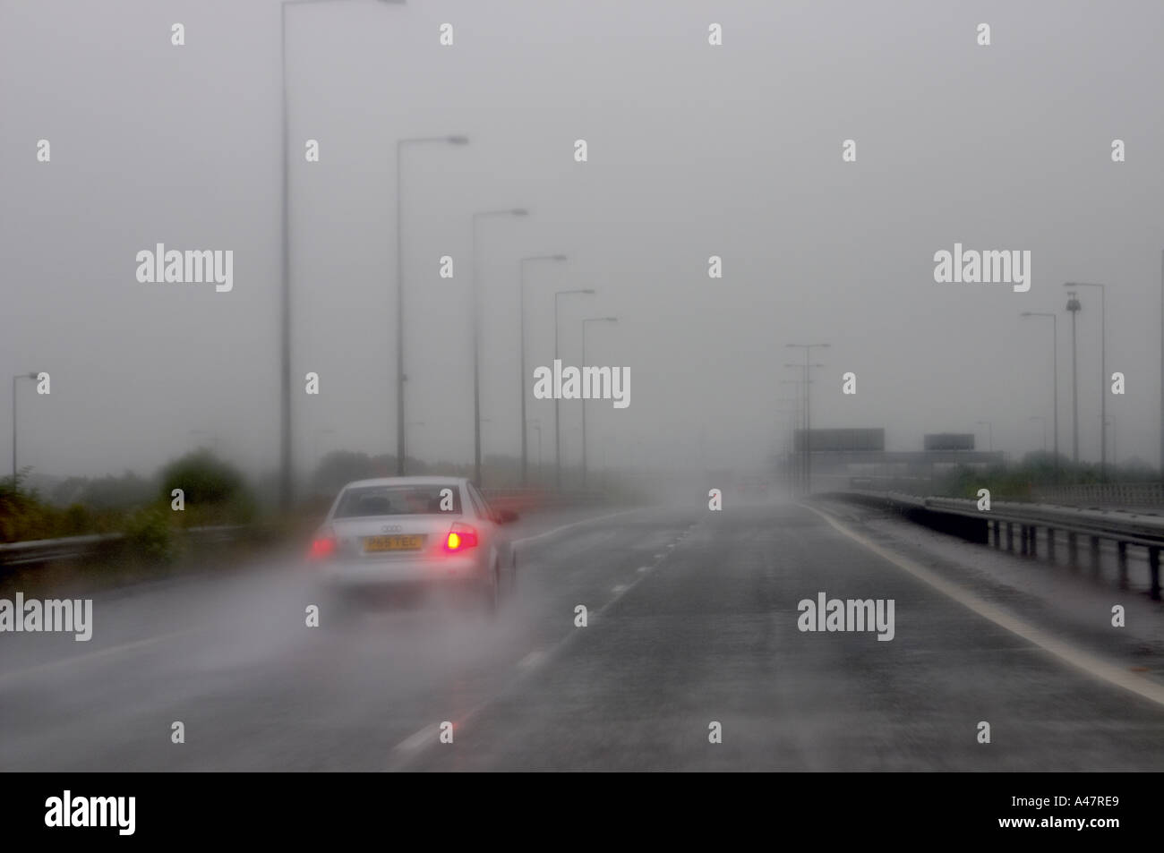 Cars on a motorway in driving rain and bad visibility dangerous driving ...