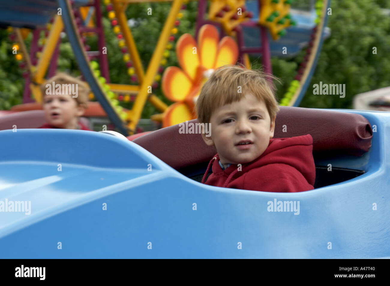 Young boy on fairground ride Stock Photo - Alamy