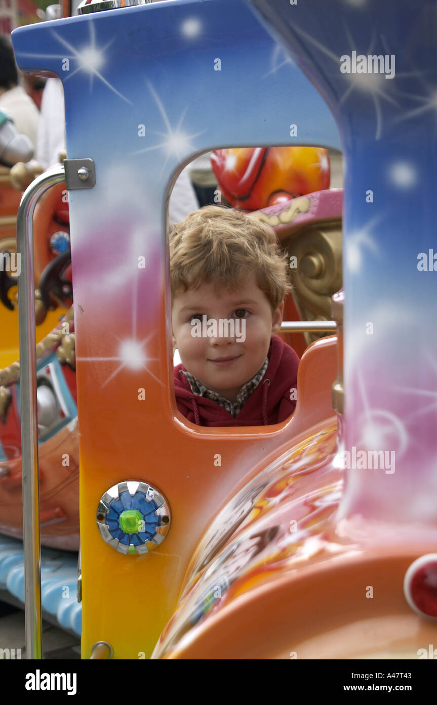 Young boy on fairground ride Stock Photo - Alamy