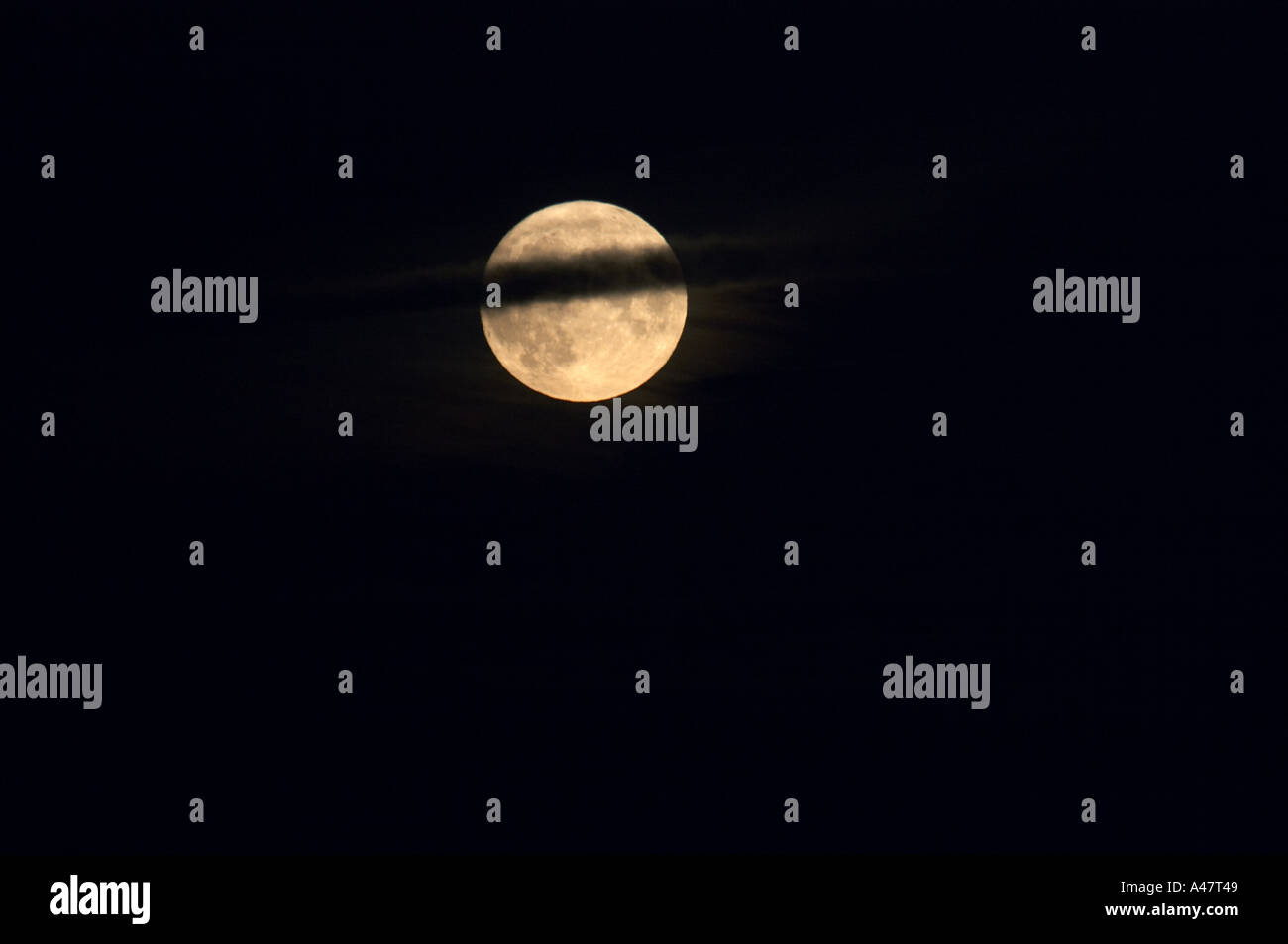 Full moon with line of cloud in front of it Stock Photo - Alamy