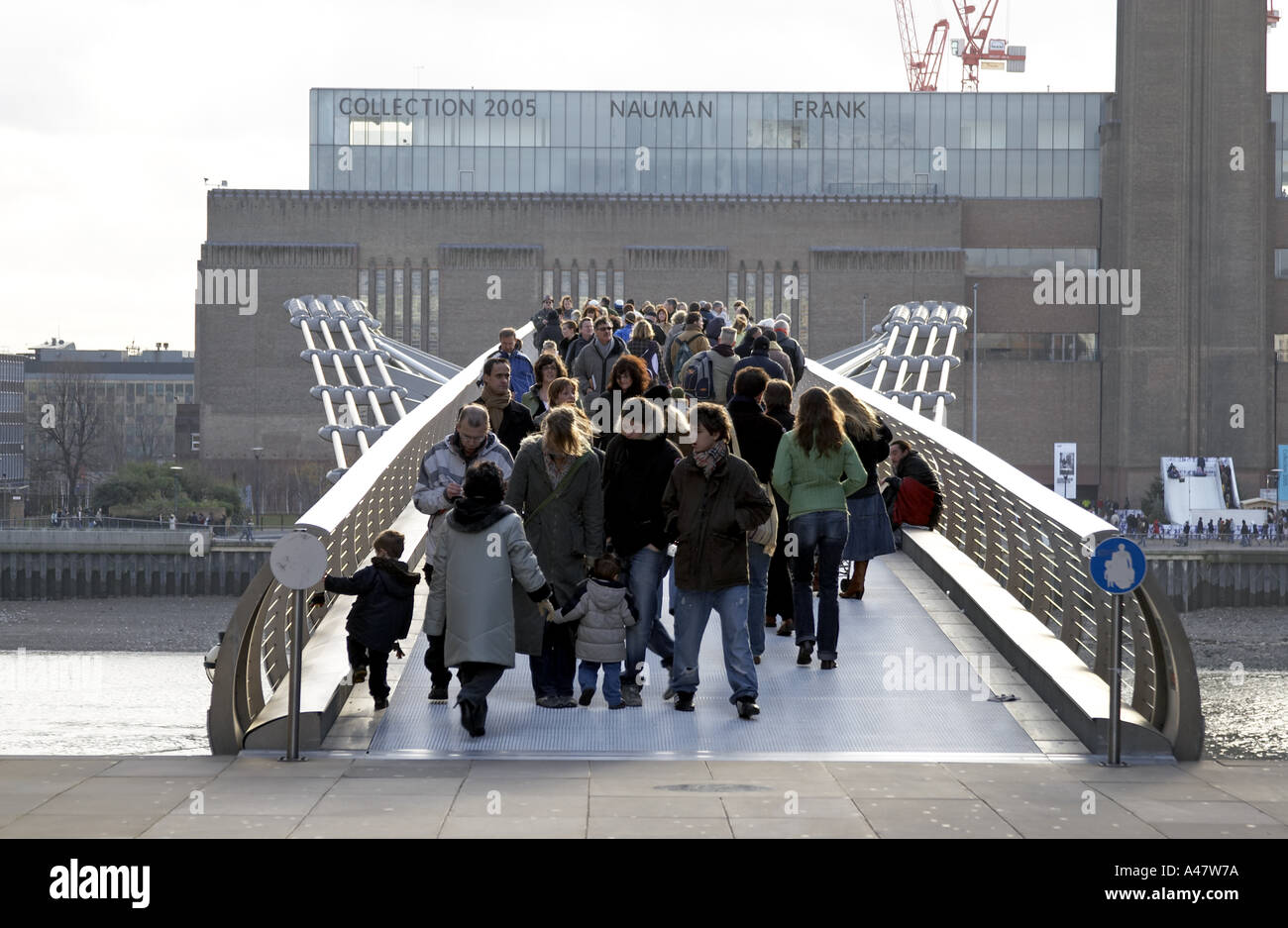 People on Millennium Bridge in winter with Tate Modern London EC4 and ...