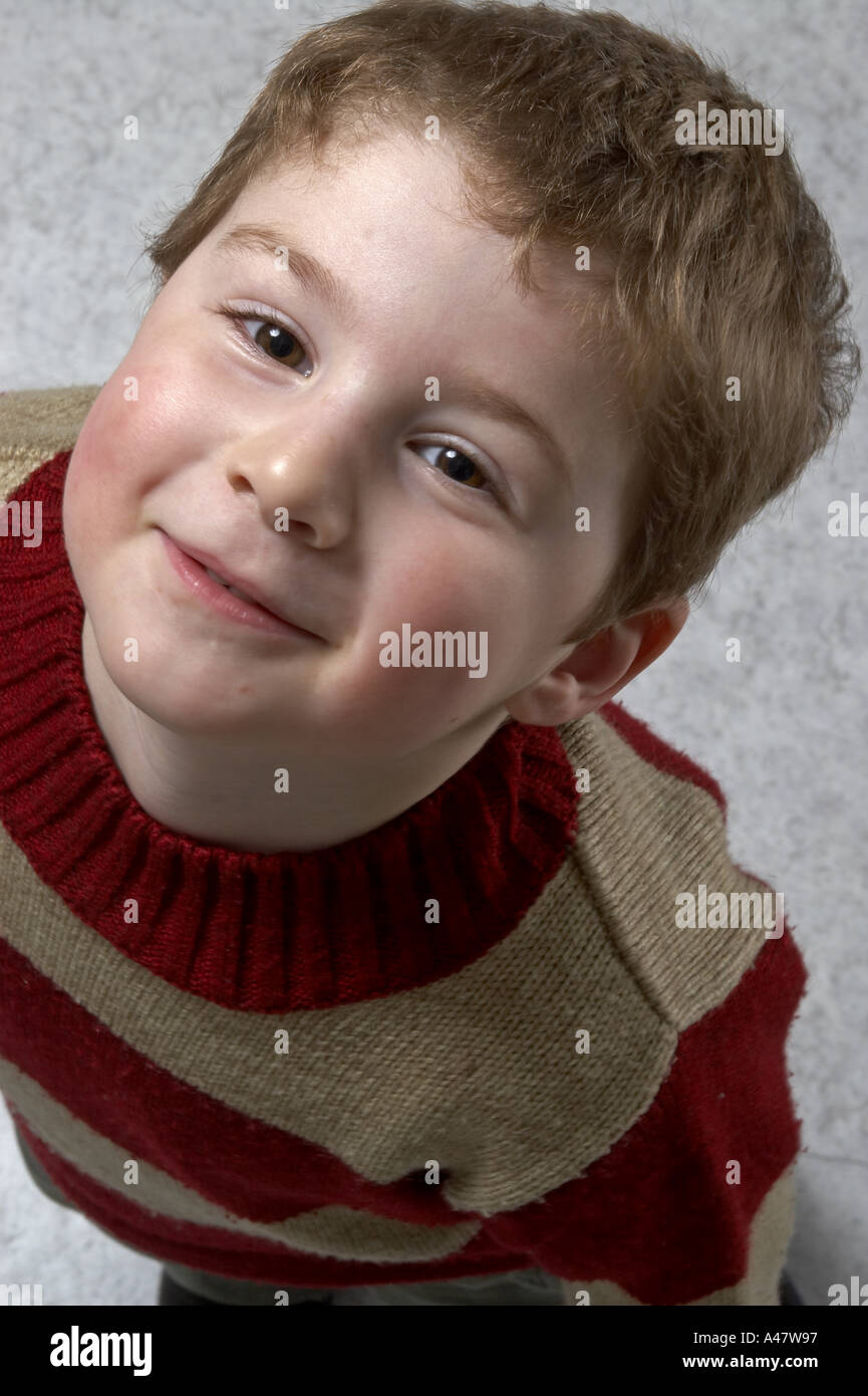 Portrait of young boy looking up and smilling at camera Stock Photo - Alamy