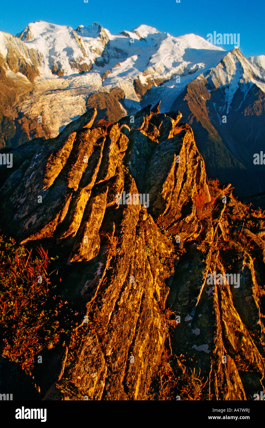 Alpine red granite glowing in the late sun with the chain of Mont Blanc ...