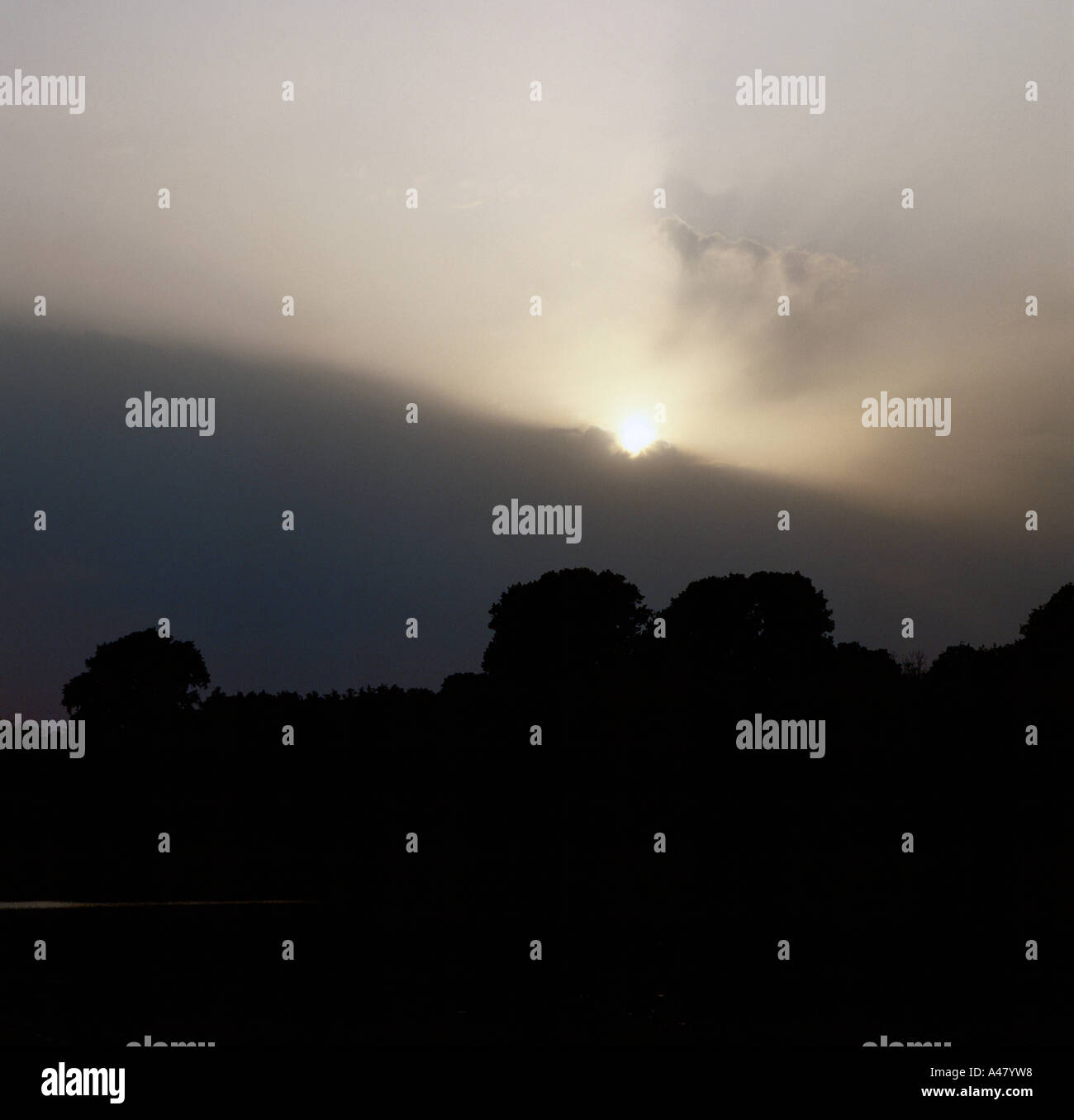 Sun behind rain clouds Stock Photo - Alamy
