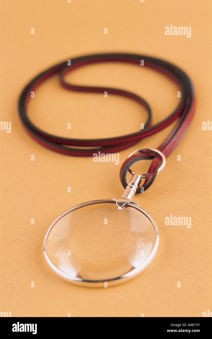 Close-up of a magnifying glass tied to a string Stock Photo - Alamy