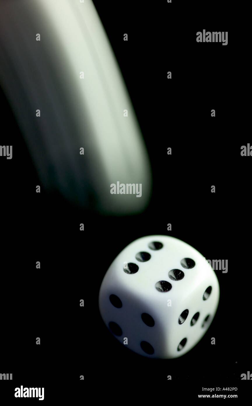 Dice being rolled with the figure six showing Stock Photo - Alamy
