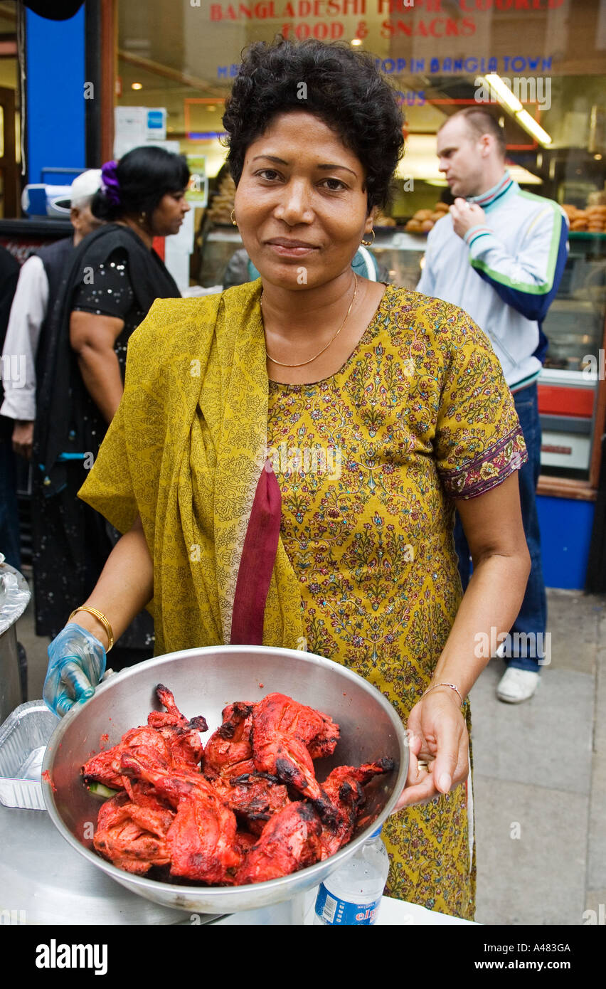 A stall holder in Brick Lane selling tandoori chicken during the ...