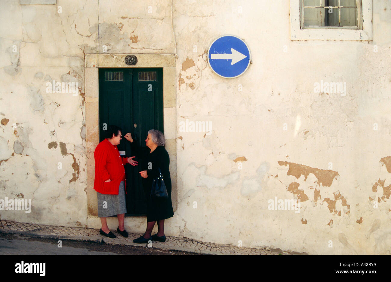 Women talking at housedoor Stock Photo - Alamy