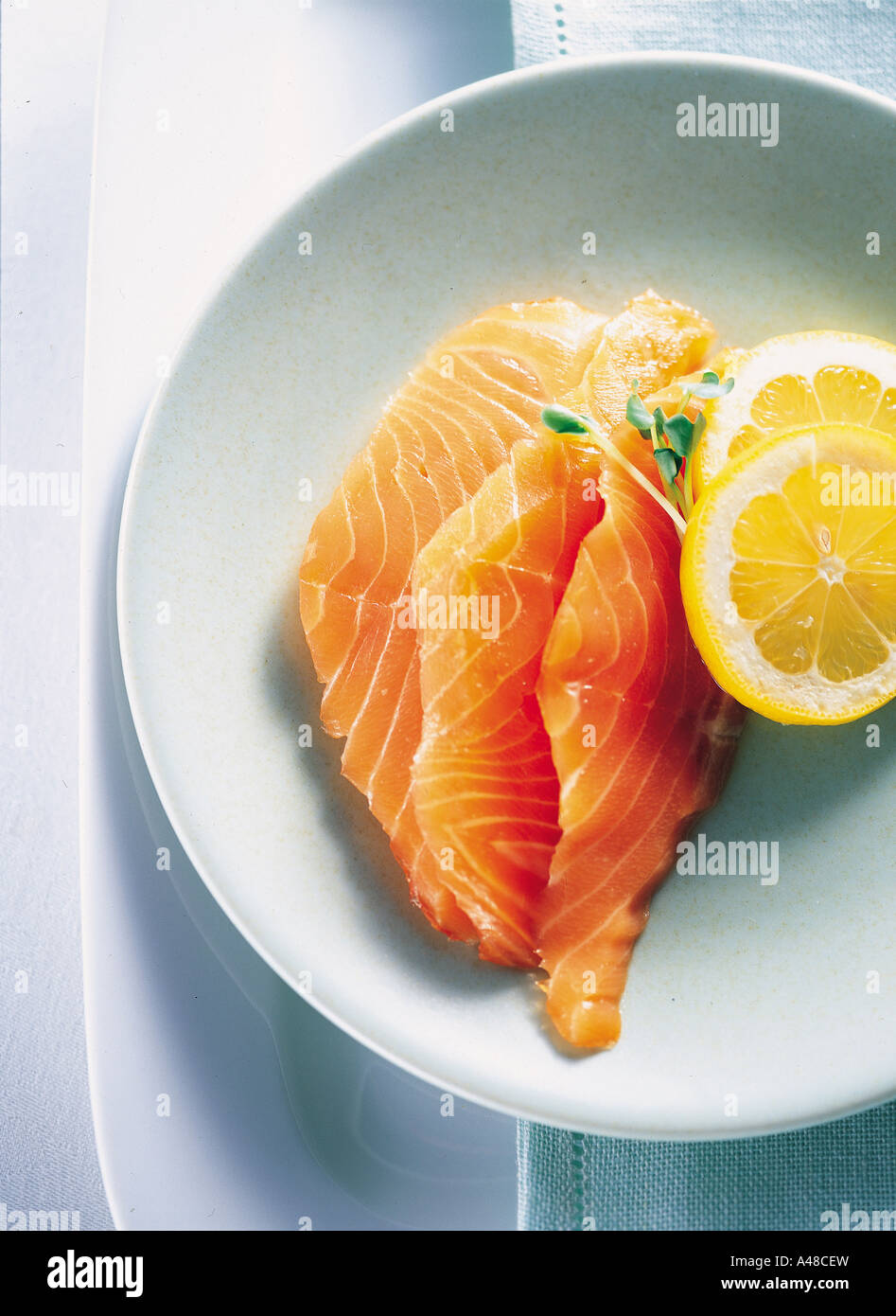 High angle view of fish fillets with slices of lemon Stock Photo - Alamy