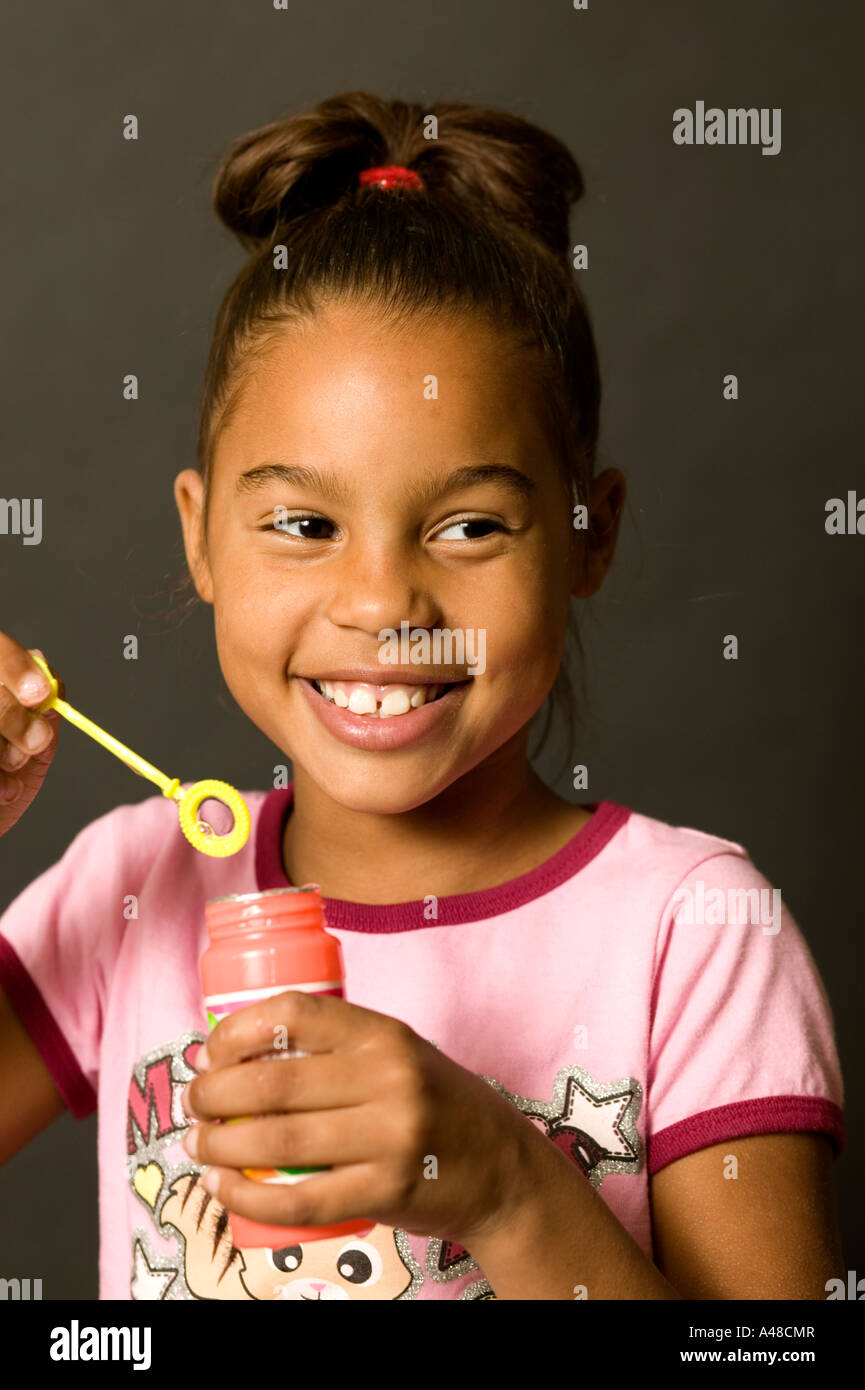 Girl holding wand, smiling Stock Photo - Alamy
