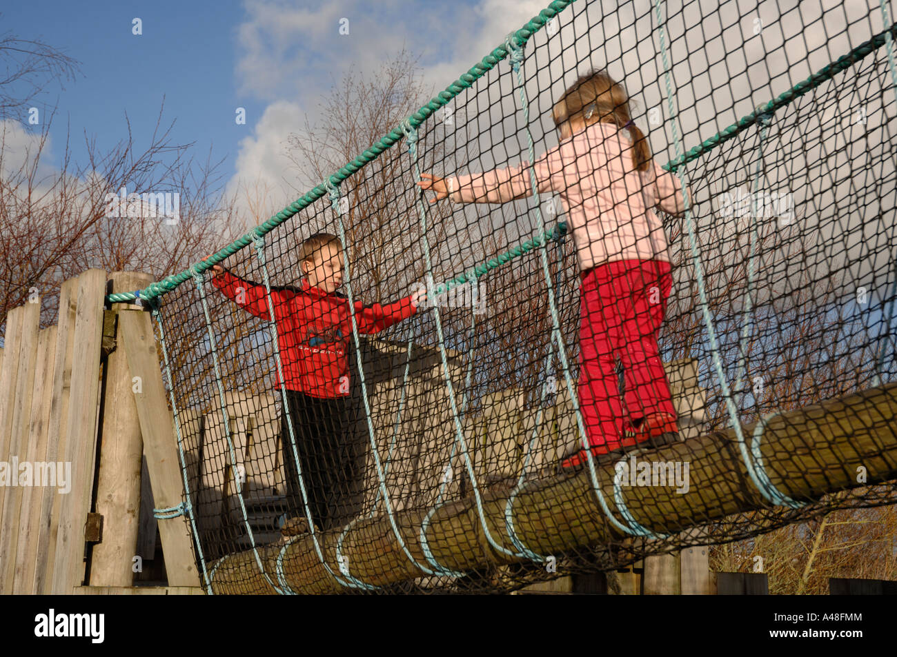 Young boy and girl climbing adventure playground Folly Farm ...