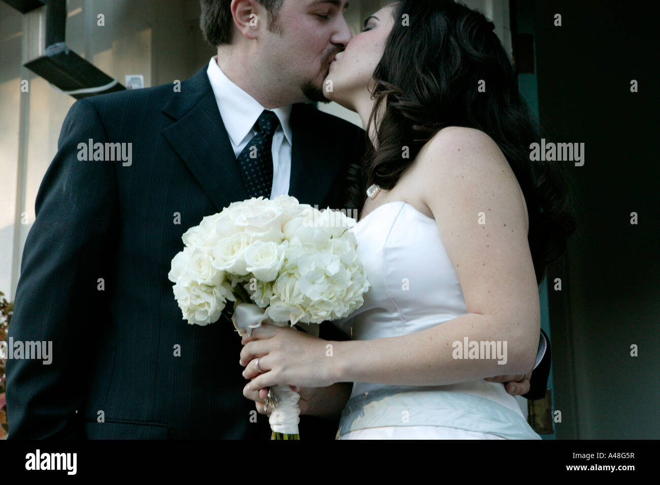 Married couple kissing Stock Photo - Alamy