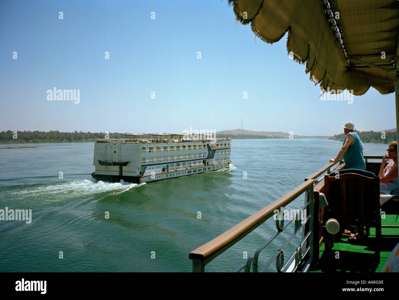 A cruise boat passes another on the Nile river between Luxor and Aswan ...