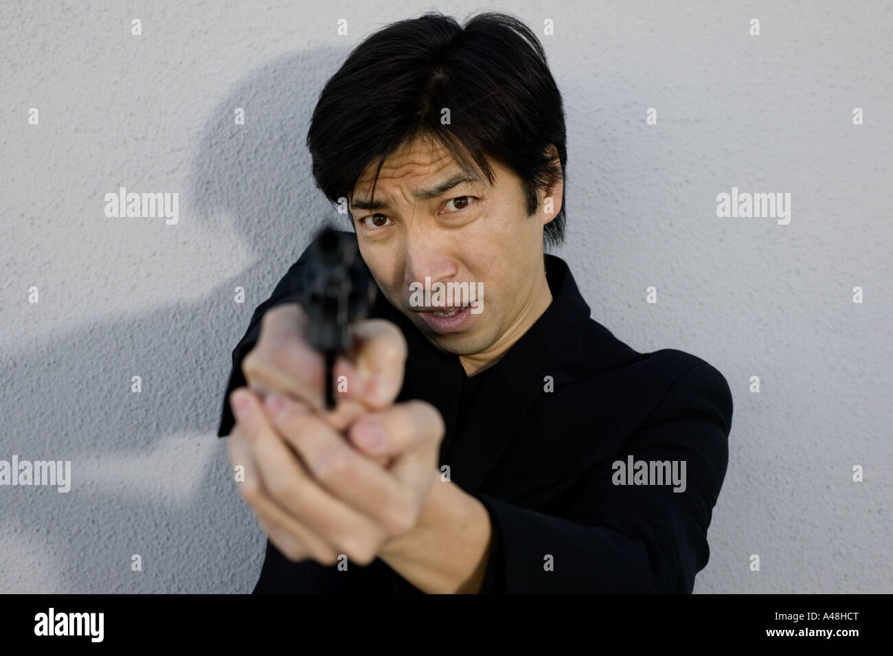 Mature man holding gun, portrait Stock Photo - Alamy