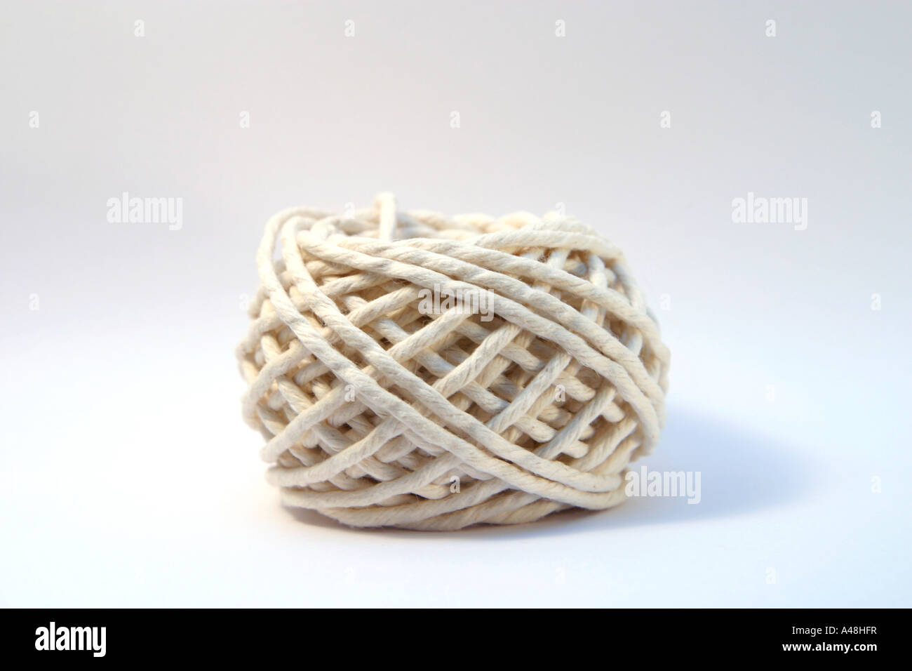Ball of string against a white background Stock Photo - Alamy