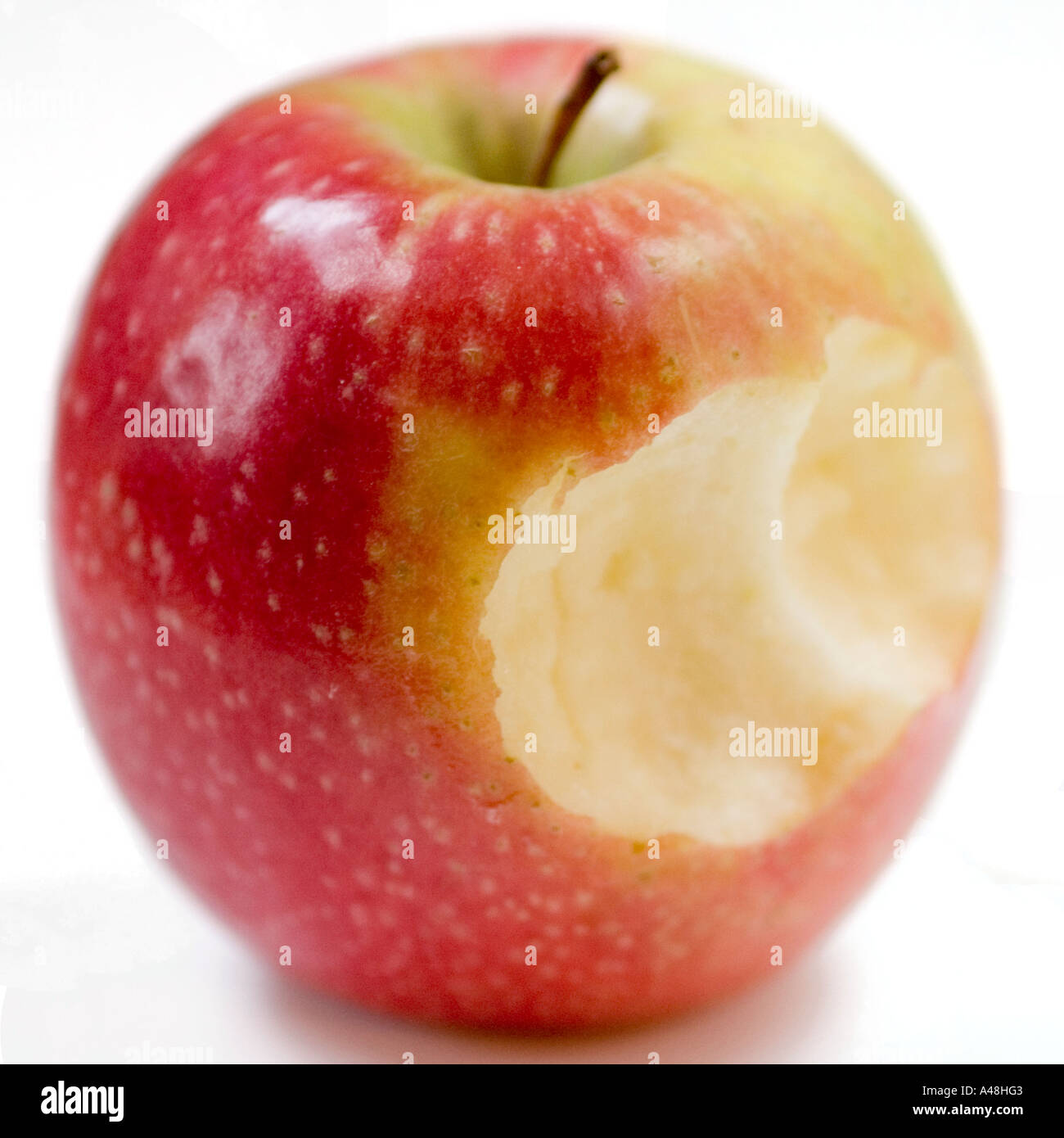 One shiny red eating apple with bite out white background Stock Photo ...