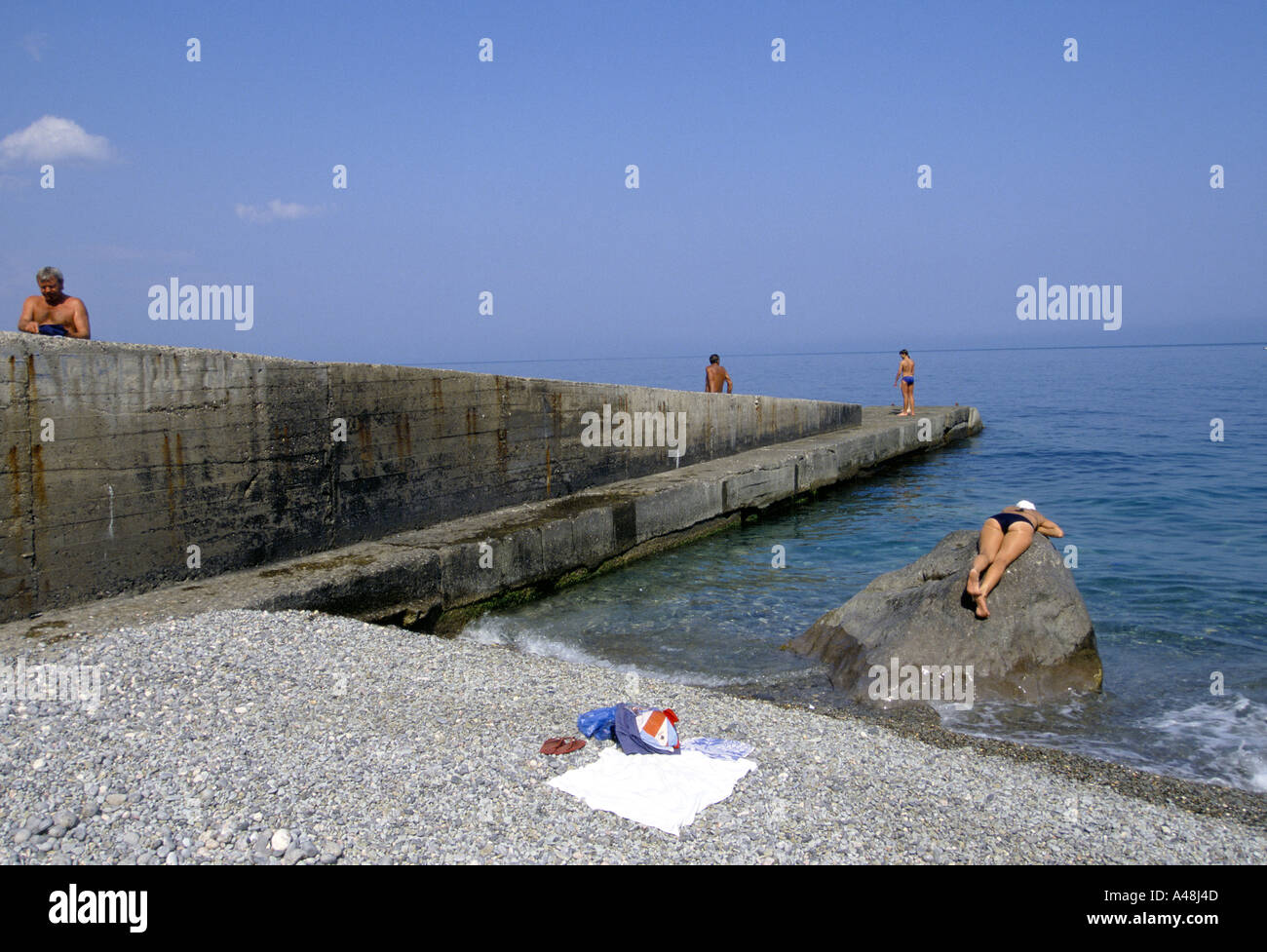 Female sunbathing on a rock hi-res stock photography and images - Alamy