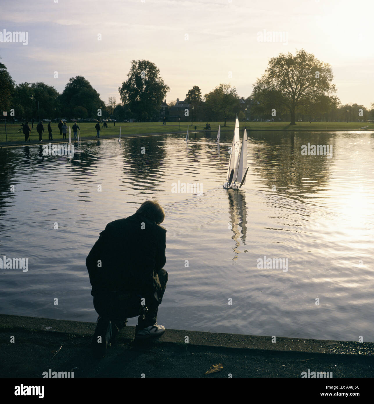 Man at Clapham common model yacht sailing pond London Stock Photo - Alamy