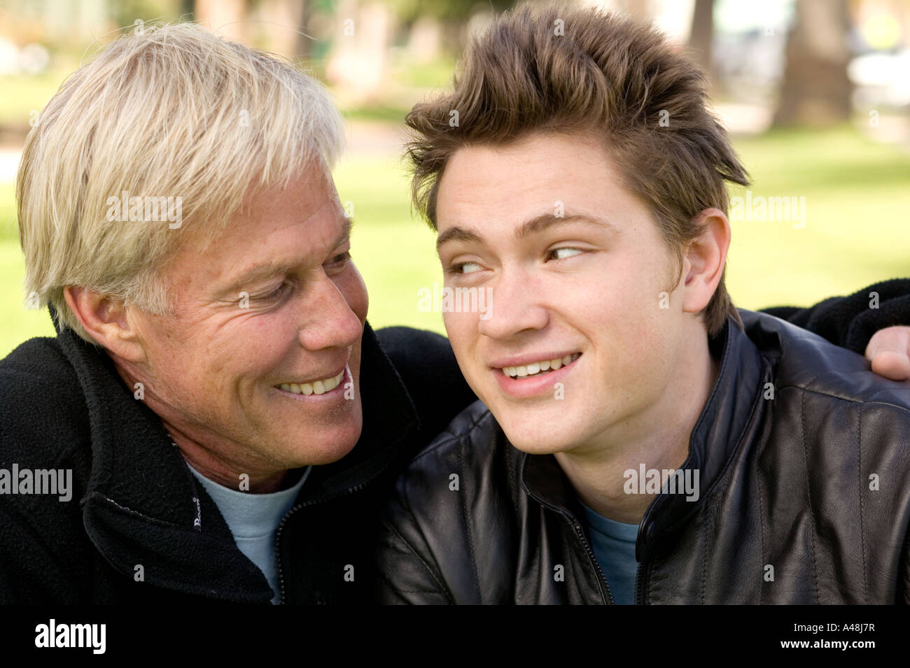 Grandson and grandfather smiling Stock Photo - Alamy