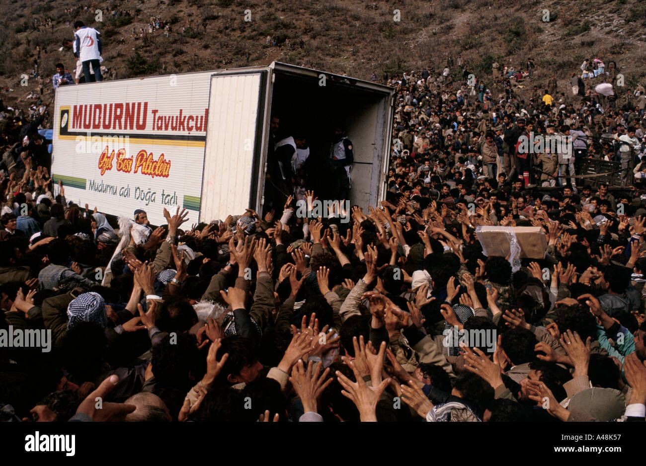 Kurdish refugees from north Iraq mob a food aid truck at Isikveren ...
