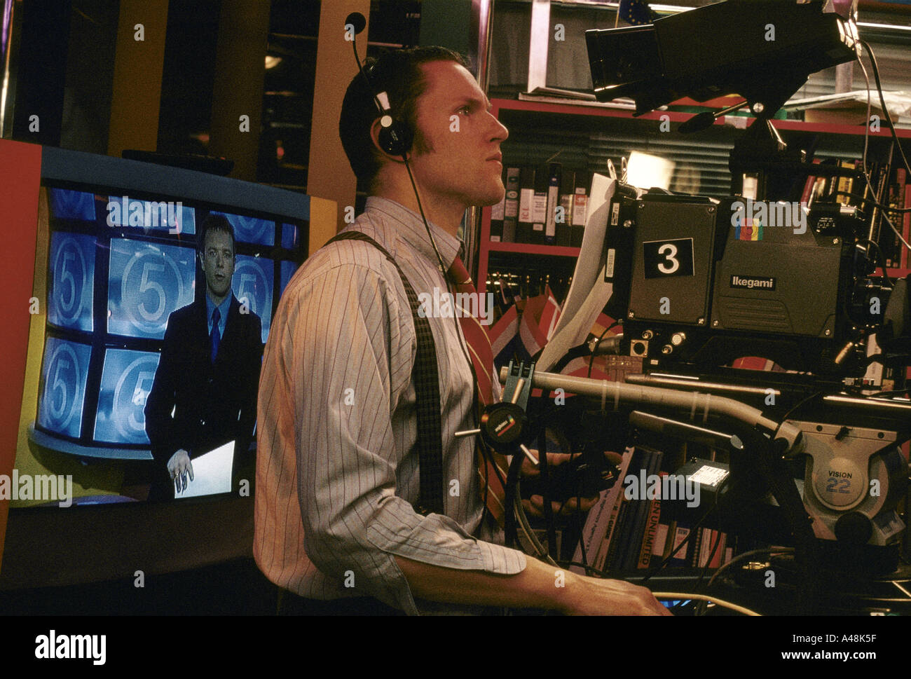 camerman filming newsreader in channel 5 newsroom studio Stock Photo ...