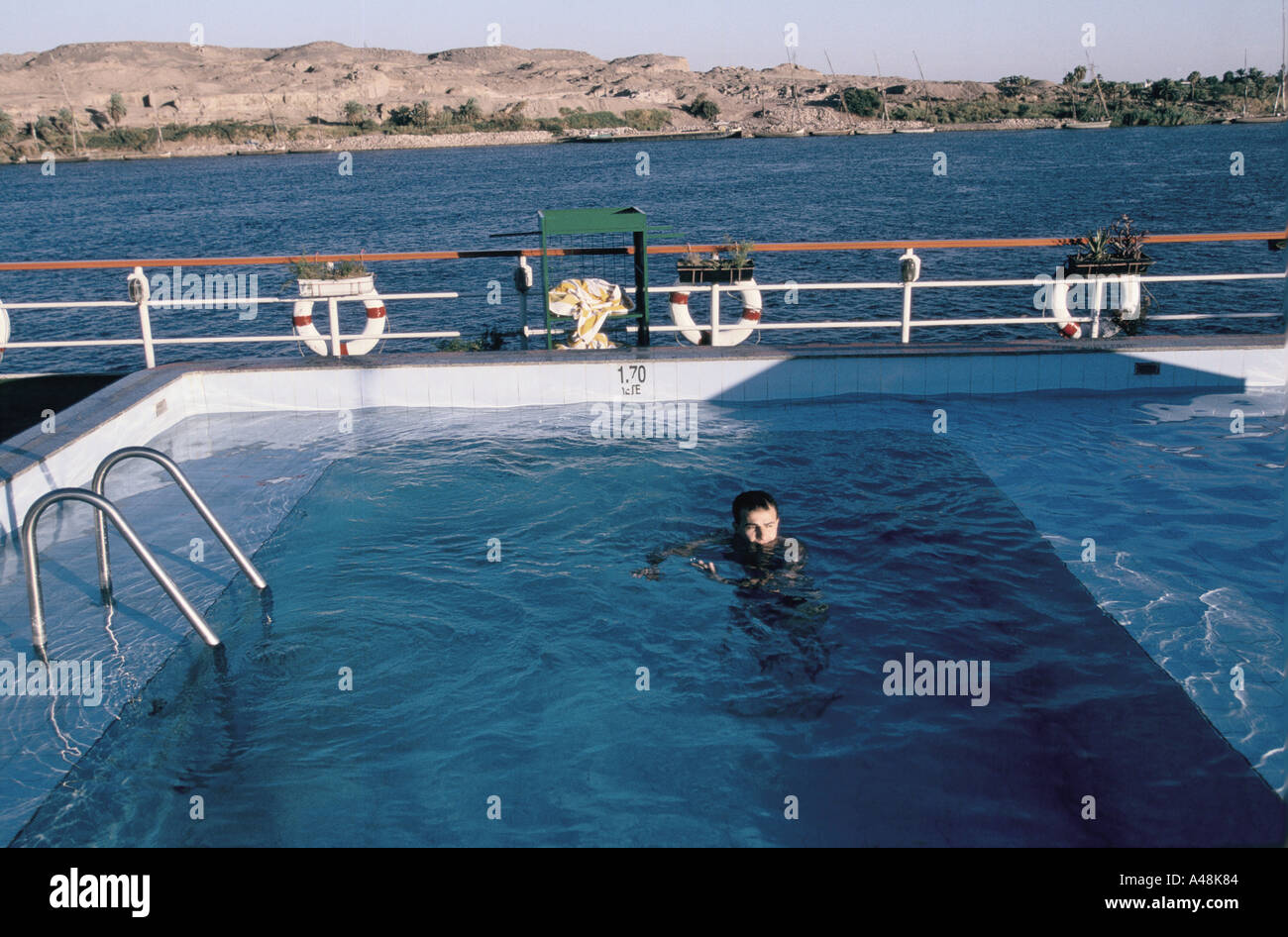 Passenger swimming in a pool on the top deck of the cruise ship Soleil ...