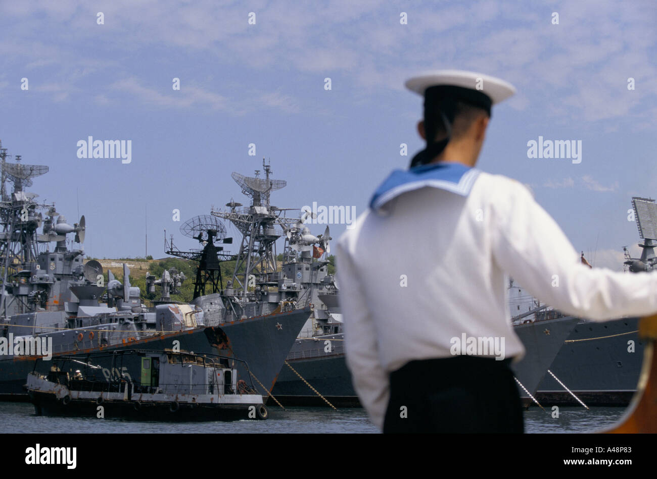 Russian sailor on sentry watch on his ship in sebastopol dockyard black ...